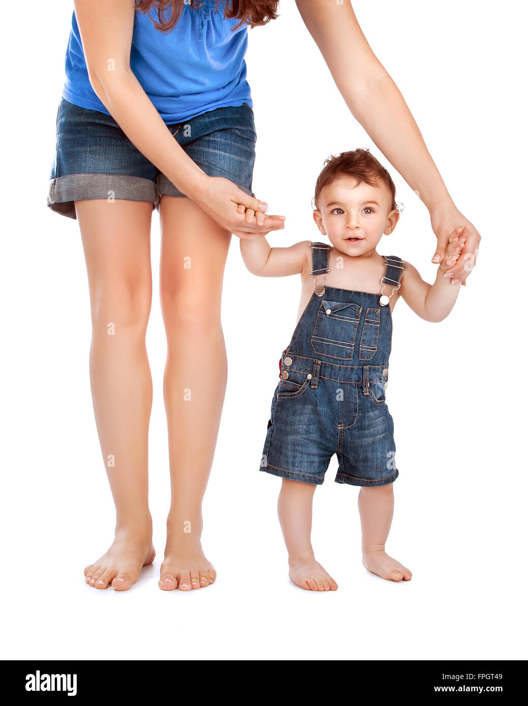 Mother teaching her cute little son to walk, holding hands, body part ...