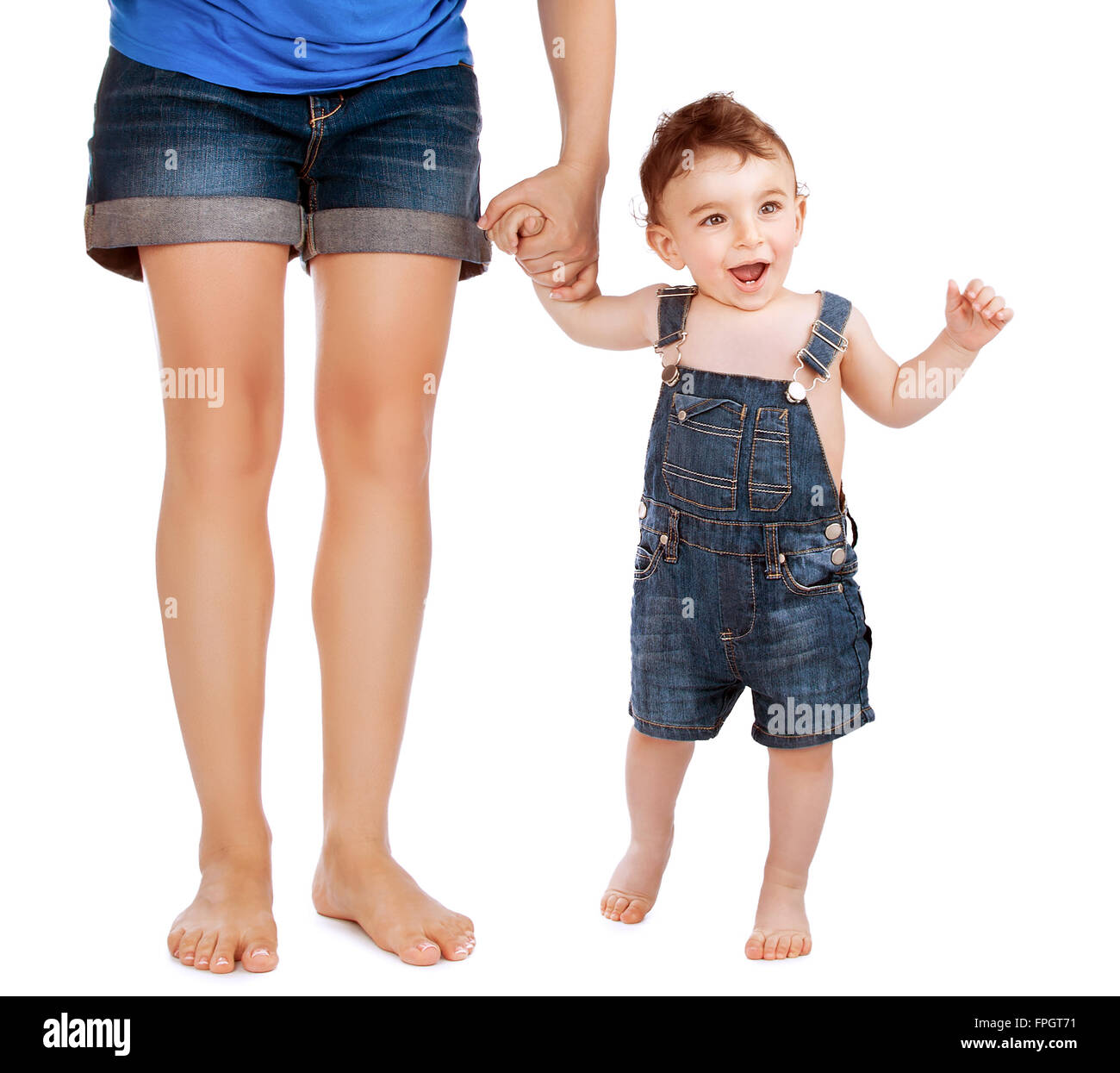 Mother teaching her cute little son to walk, holding hands, body part ...