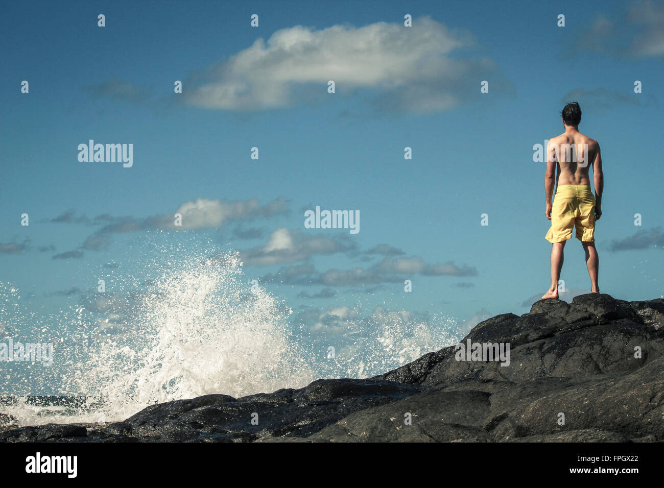 brave man standing on the rocks of fraser island Stock Photo - Alamy