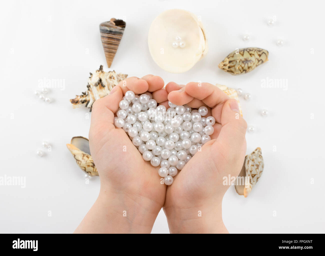 hands with pearl beads and seashells Stock Photo - Alamy