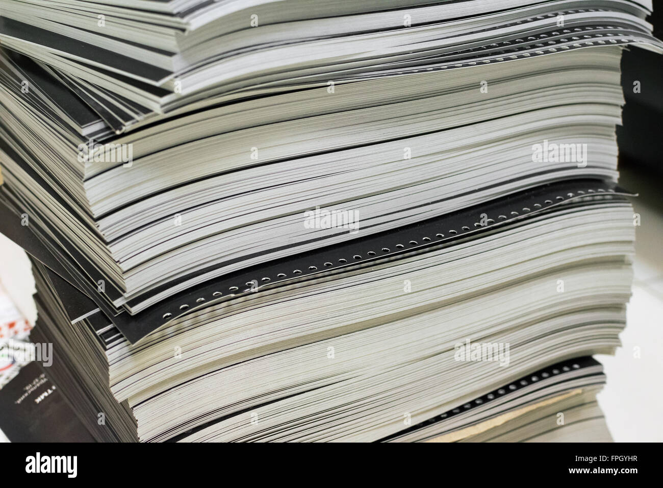 stack of black perforated printed sheets Stock Photo - Alamy