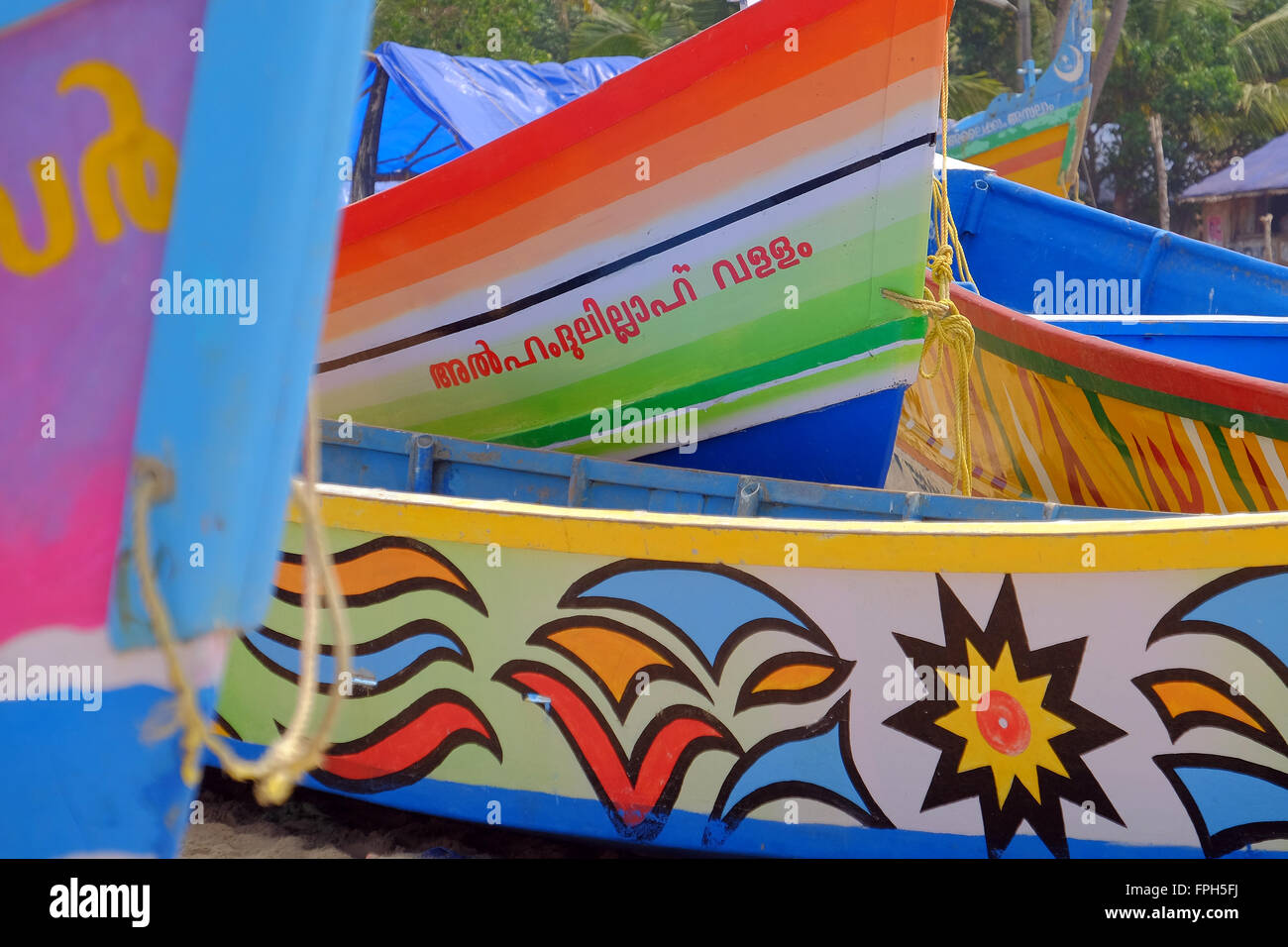 Brightly painted fishing boats on a beach in Kerala, India Stock Photo ...