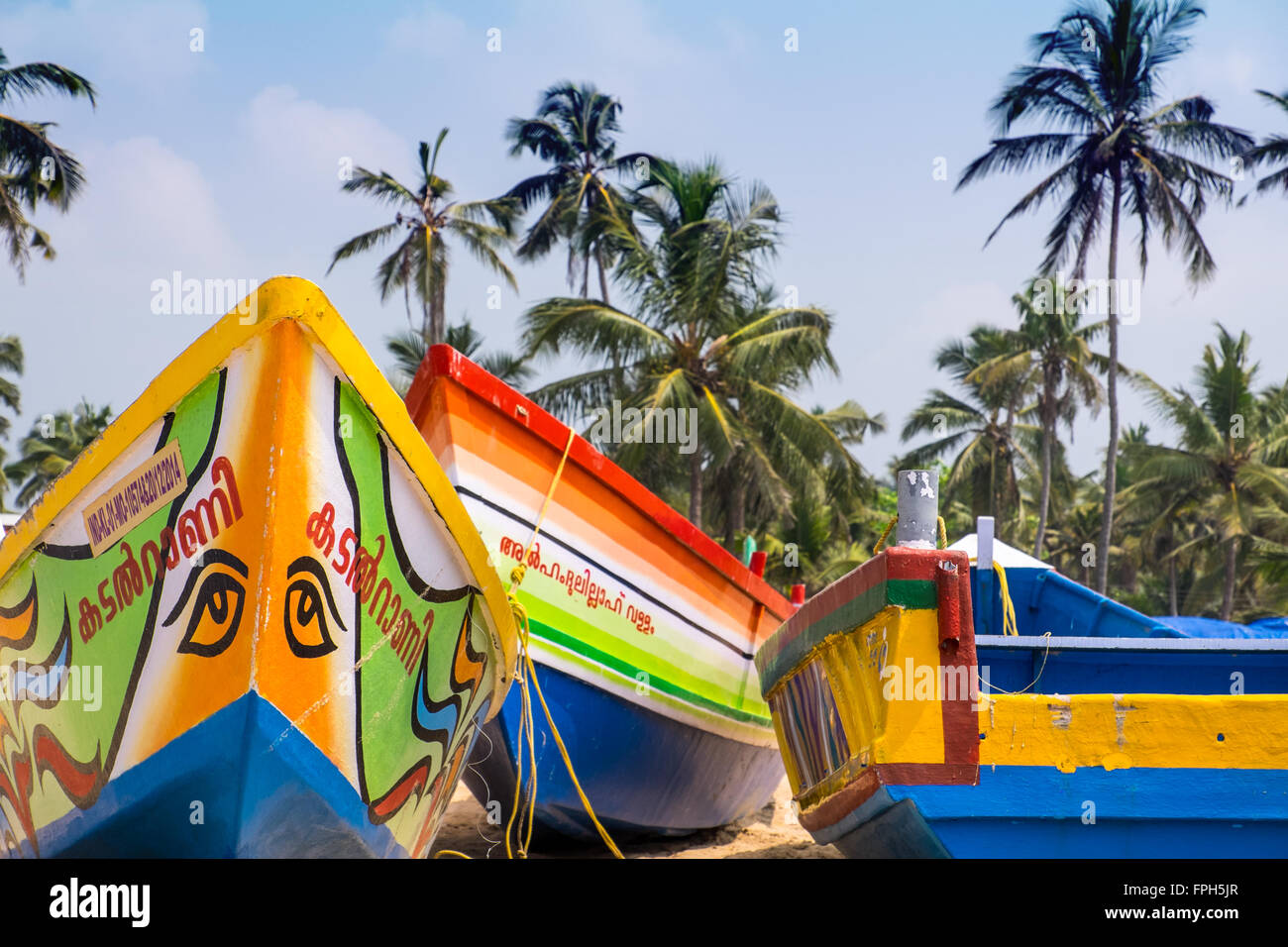 Brightly painted fishing boats on a beach in Kerala, India Stock Photo ...