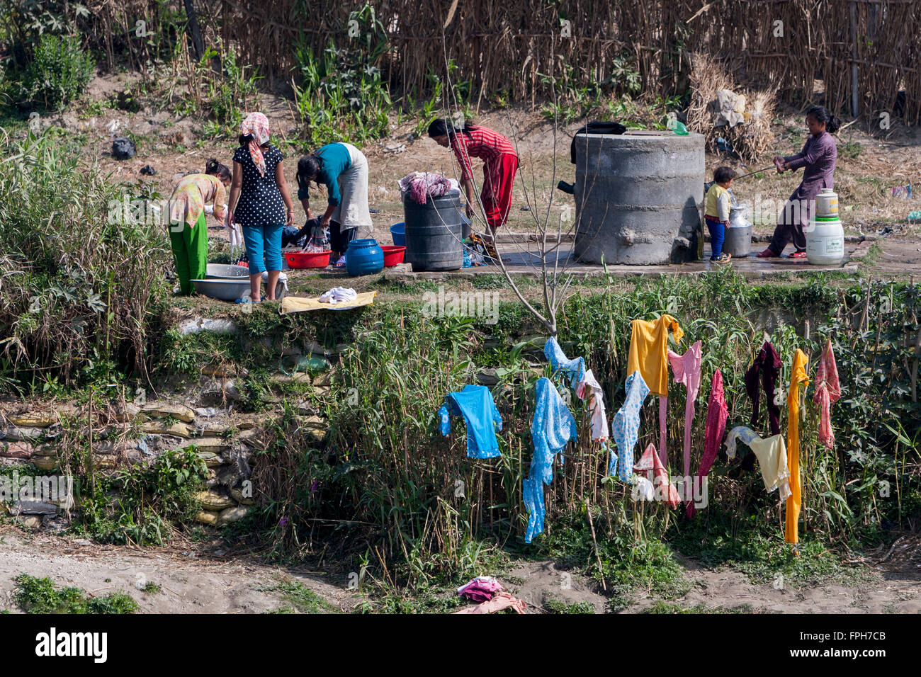 Nepal, Patan. Women Washing Clothes at a Public Well Stock Photo - Alamy
