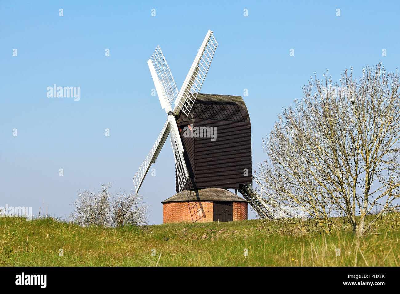 English wooden Post Mill Village Windmill in against a Blue Sky Stock ...