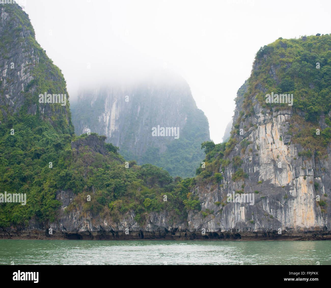 View of a limestone island in the dramatic and mysterious Halong Bay ...