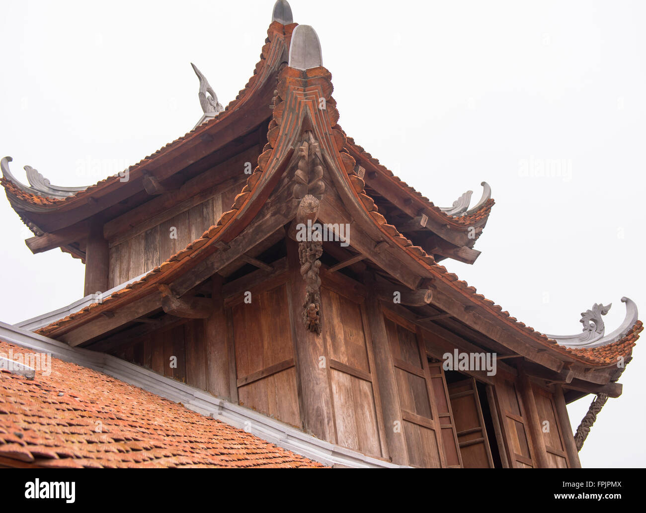 Curved wooden roofs and tiles on the tower of But Thap Pagoda, Vietnam ...
