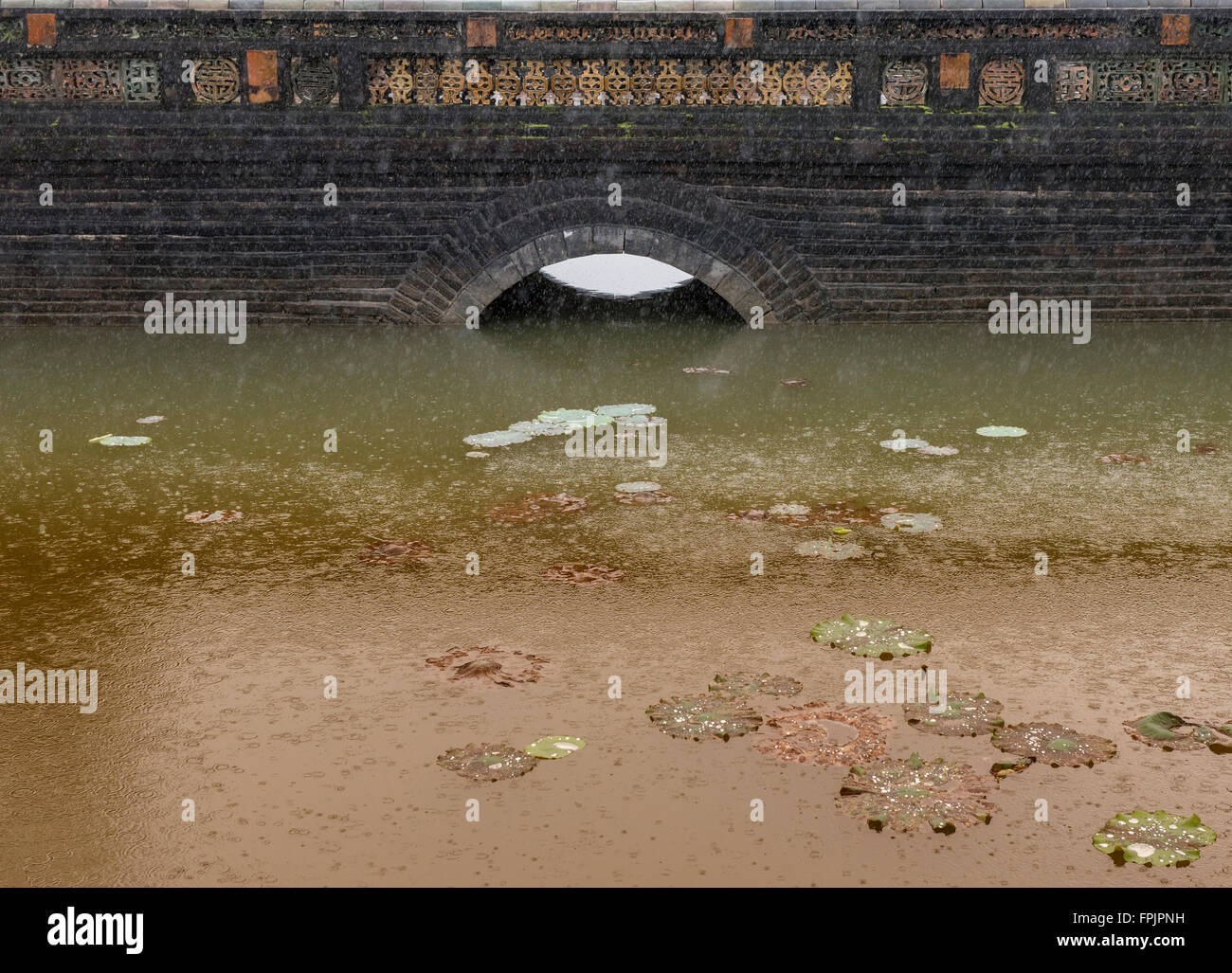 Bridge, lotus leaves and rain at the Tomb of Minh Mang, Vietnam Stock ...