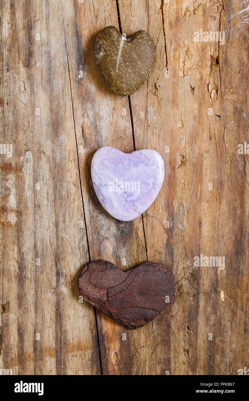 Three hearts on wooden ground Stock Photo - Alamy