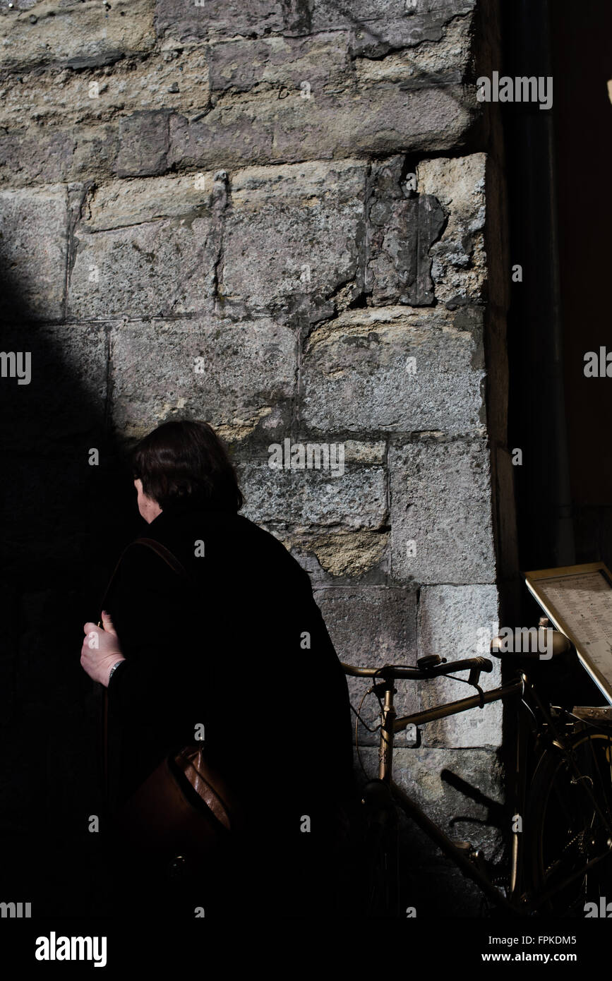 Mystical man in black clothes at the old brick wall. Rome architecture ...
