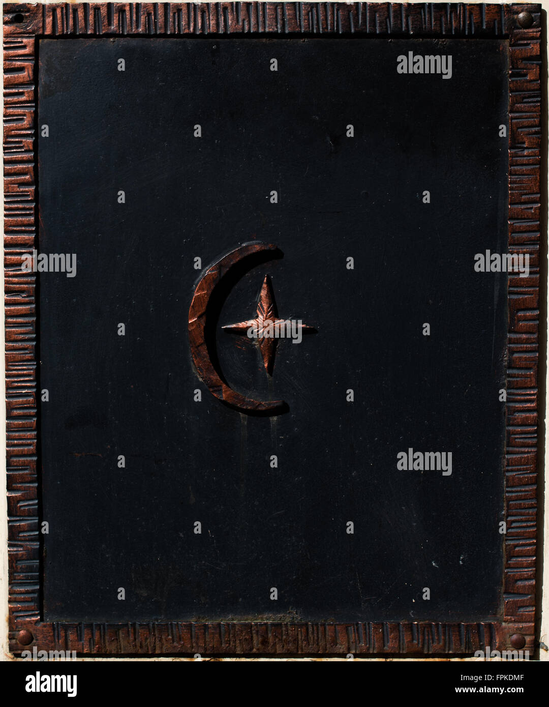 Forged muslim symbol on the old wall close up Stock Photo - Alamy