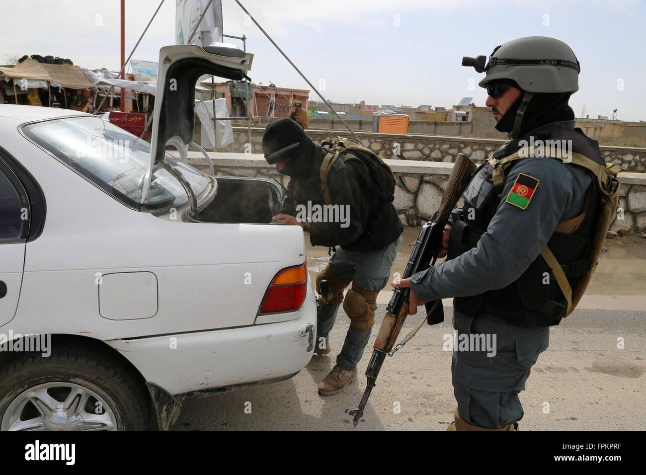 Ghazni, Afghanistan. 19th Mar, 2016. An Afghan policeman searches a ...
