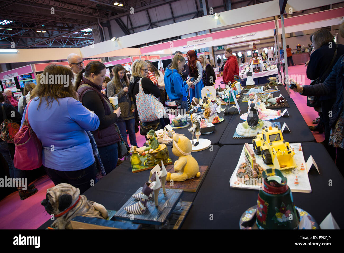 Birmingham, UK. 19th March, 2016. People viewing all the stunning cakes ...