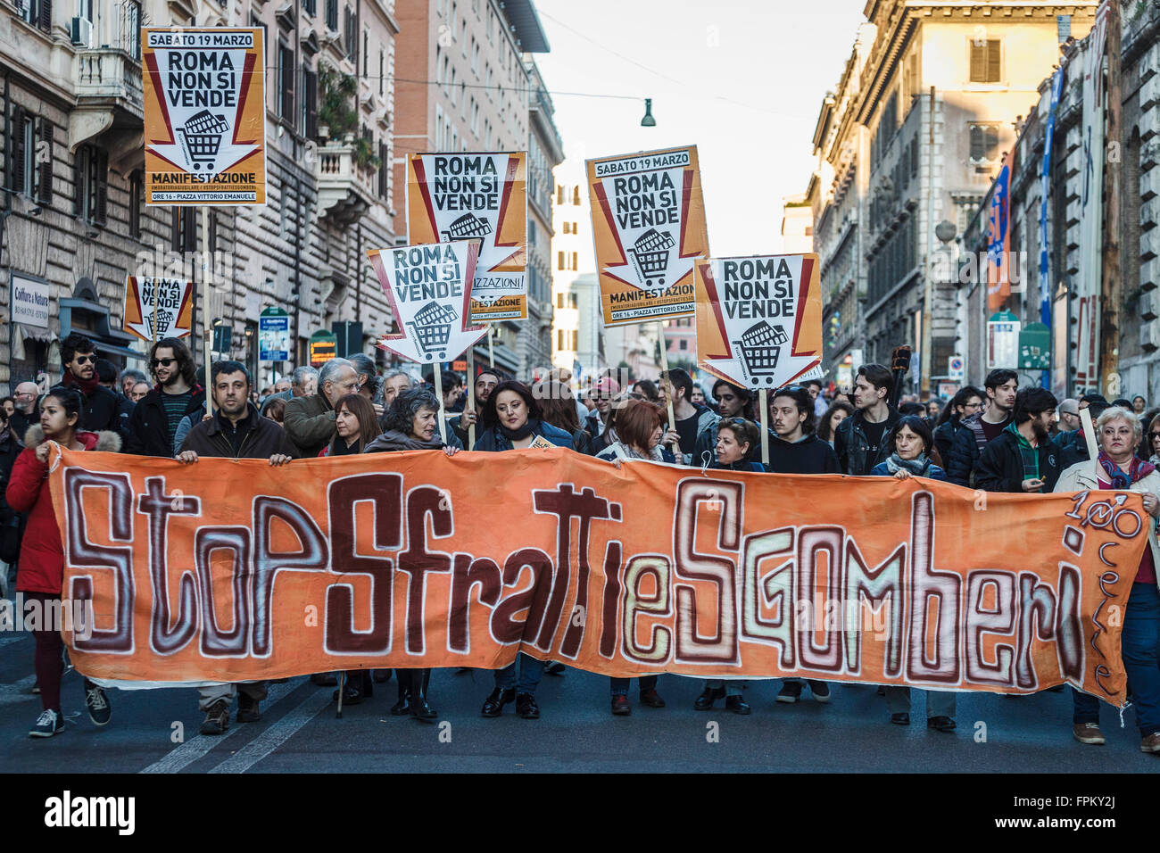 Demonstrators hold a banner reading 'Stop evictions' and shout slogans ...