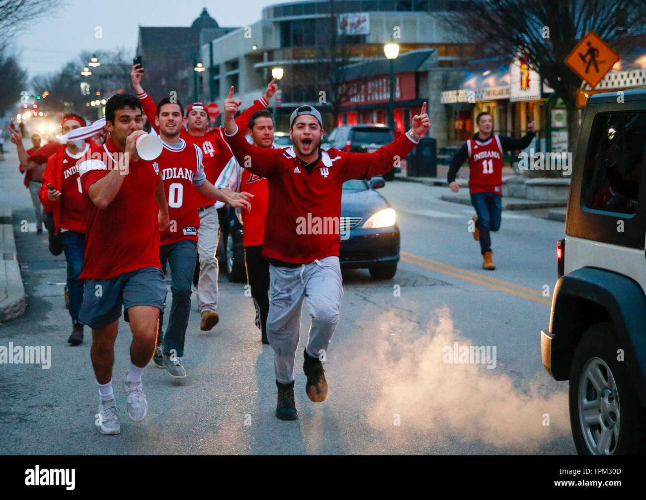 Indiana University fans run down Kirkwood Avenue cheering after the ...