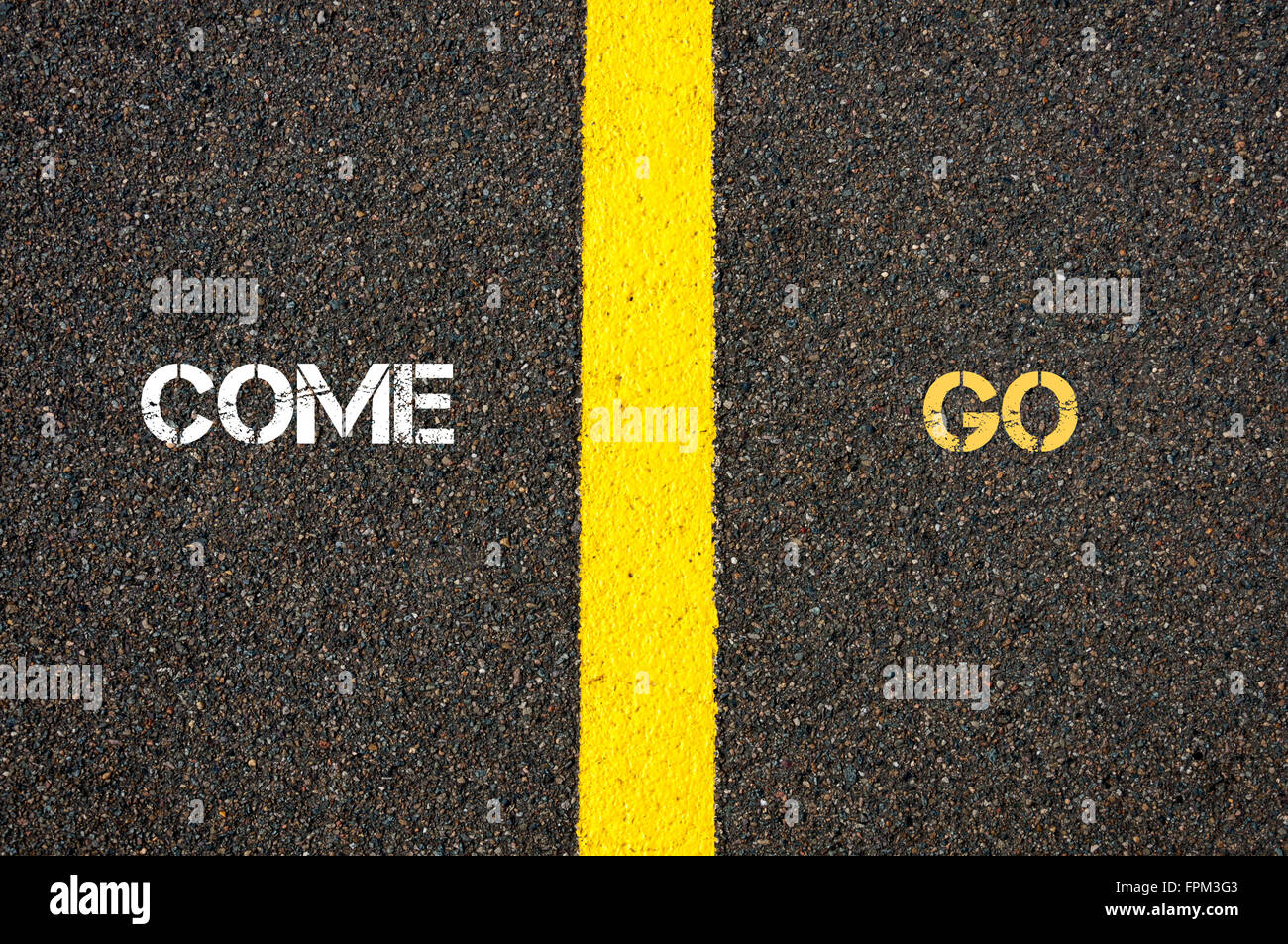 Antonym concept of COME versus GO written over tarmac, road marking ...