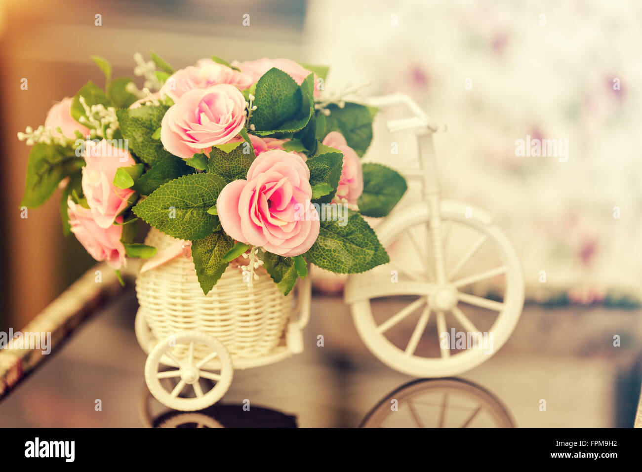 Beautiful pink flowers on the small bicycle model Stock Photo - Alamy