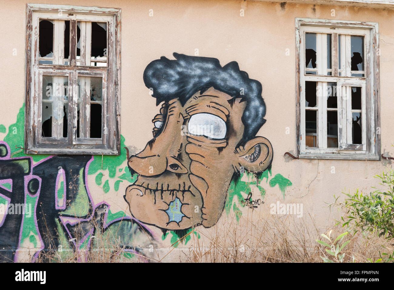 Fragment of the wall old abandoned house with broken windows and ...