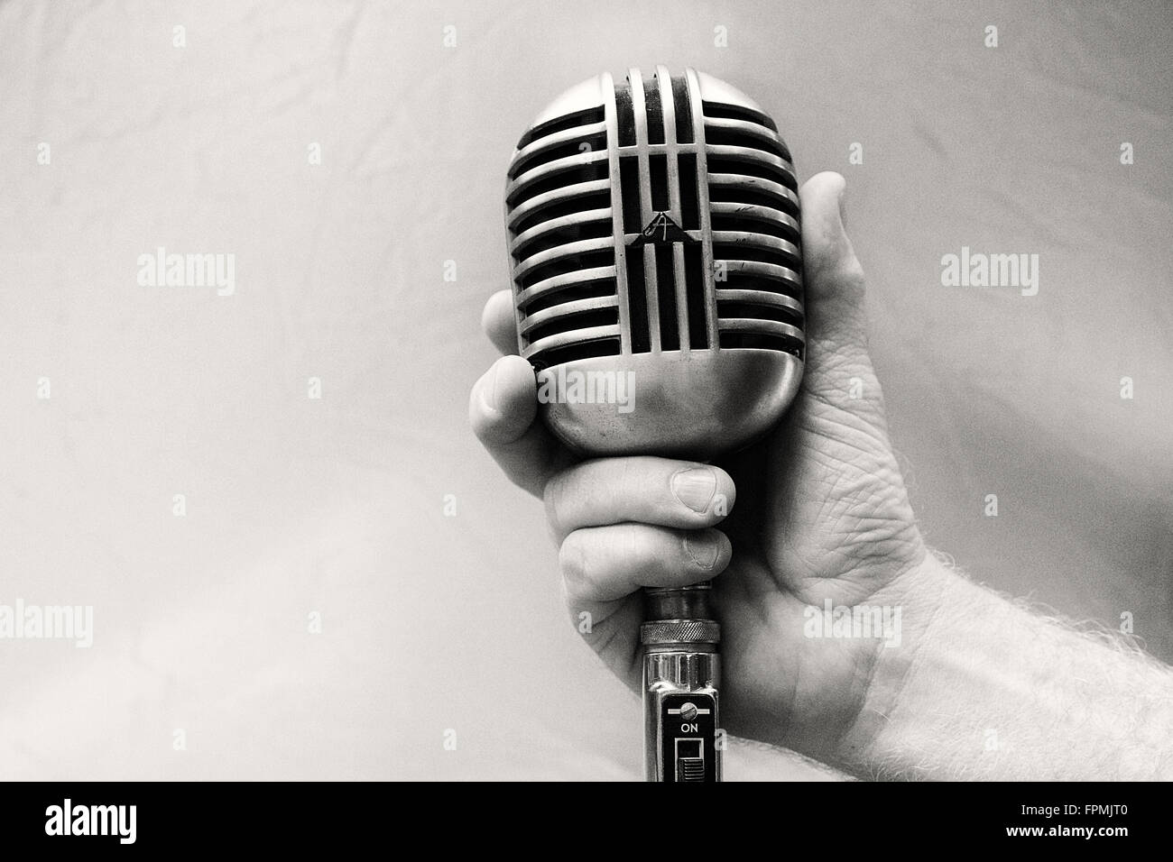 Vintage Microphone being held by a man Stock Photo - Alamy