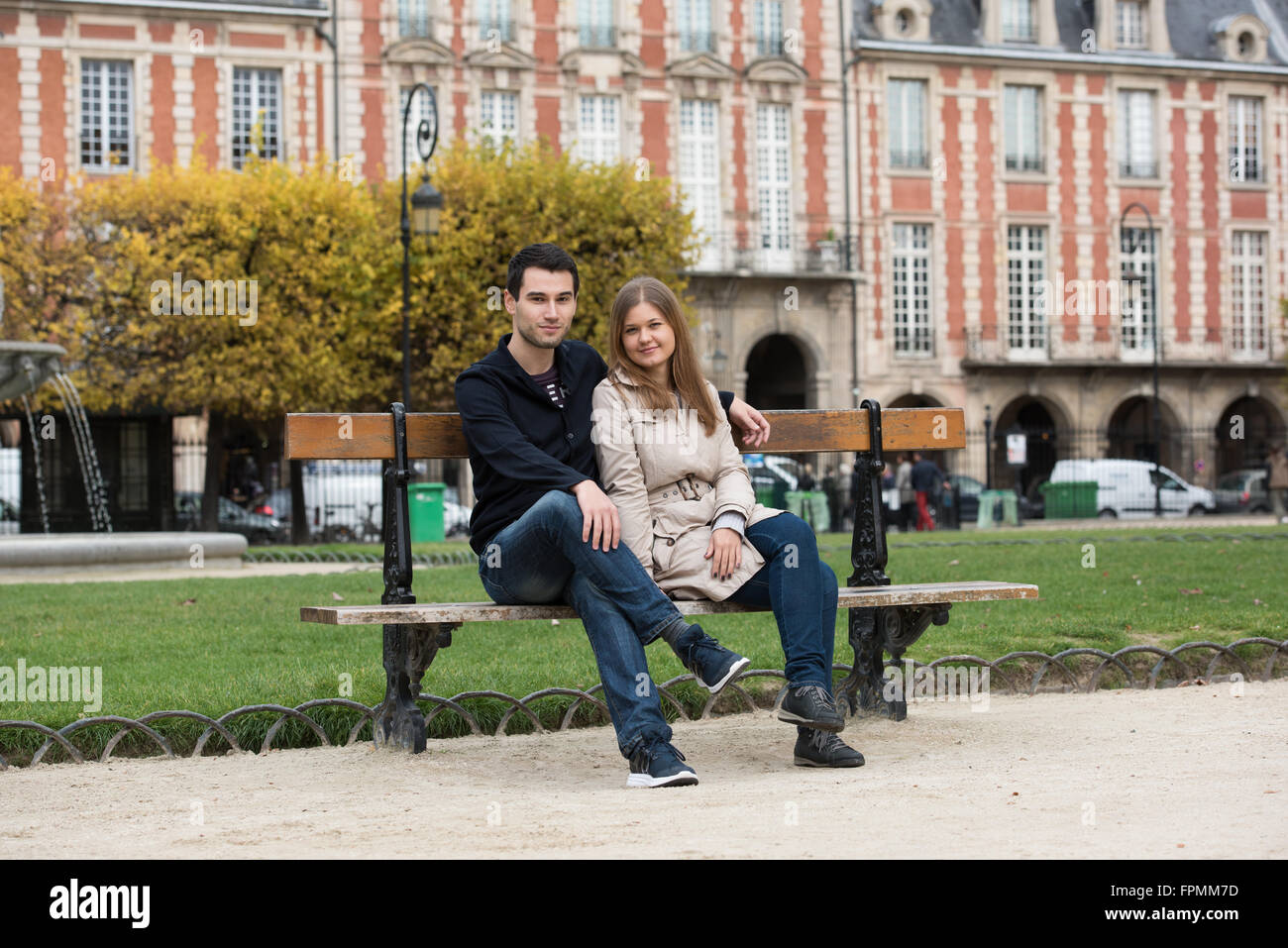 young couple having romantic conversation on the bench in park in Paris ...