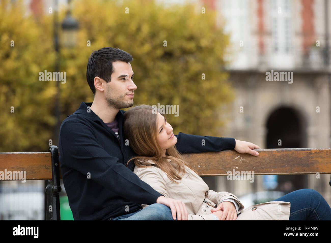 young couple having romantic conversation on the bench in park in Paris ...