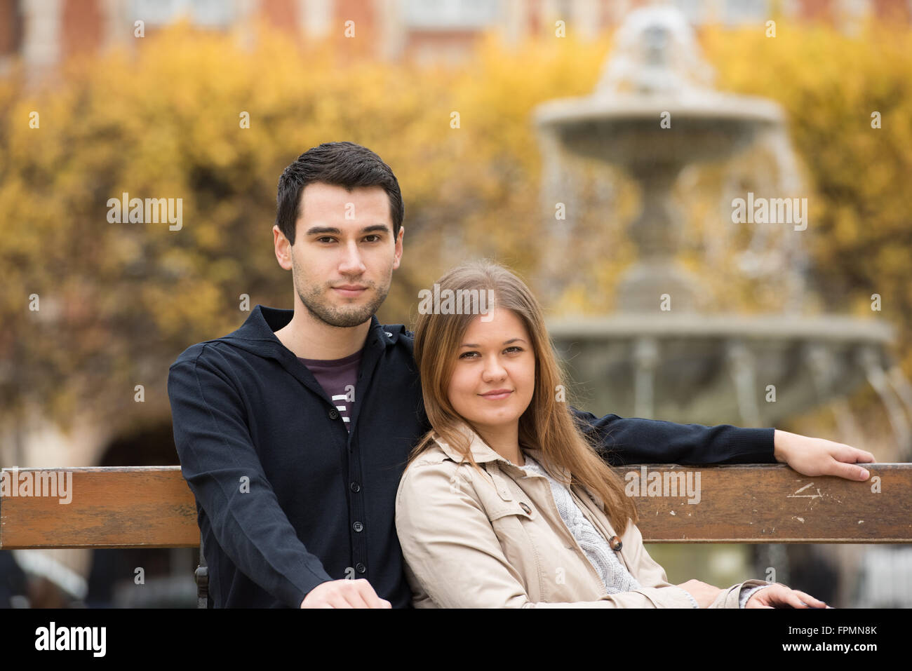 young couple having romantic conversation on the bench in park in Paris ...