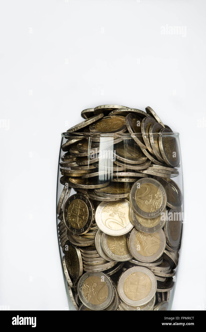 coins in glass on white background Stock Photo - Alamy