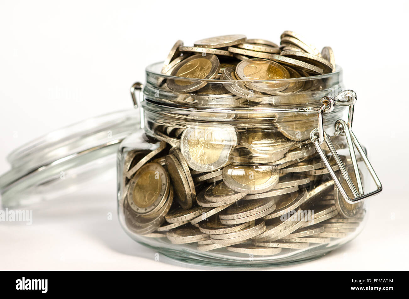 coins in glass on white background Stock Photo - Alamy
