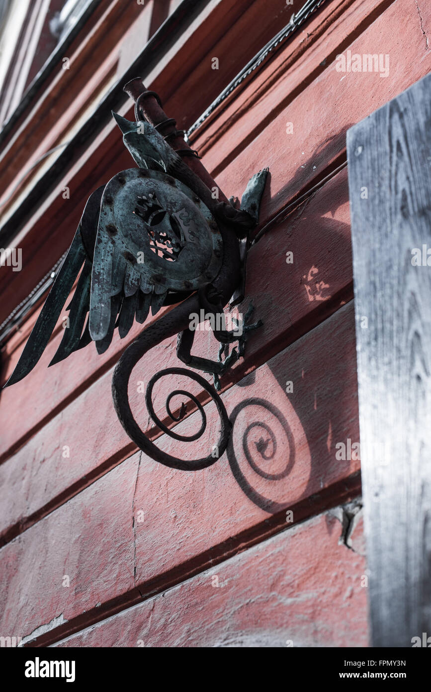 Vintage forged bird statue on the wall Stock Photo - Alamy