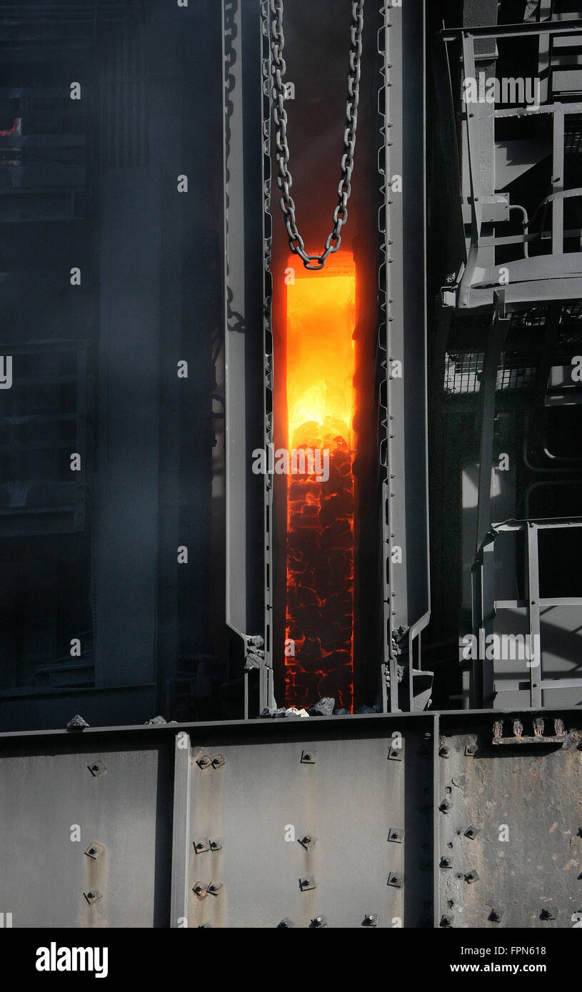 Pushing red hot coke from oven Stock Photo - Alamy