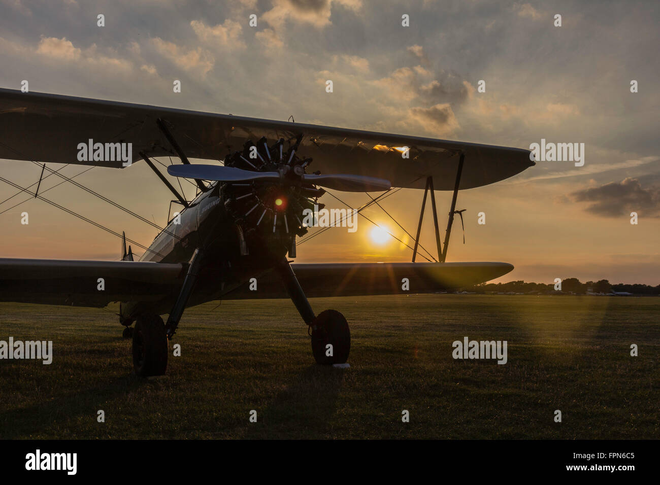 Biplane at sunset Stock Photo - Alamy