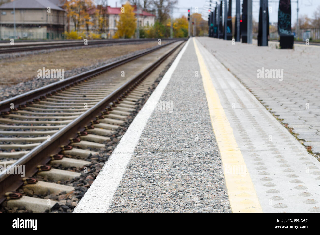 Blurred image of railway track and rail platform, diminishing ...