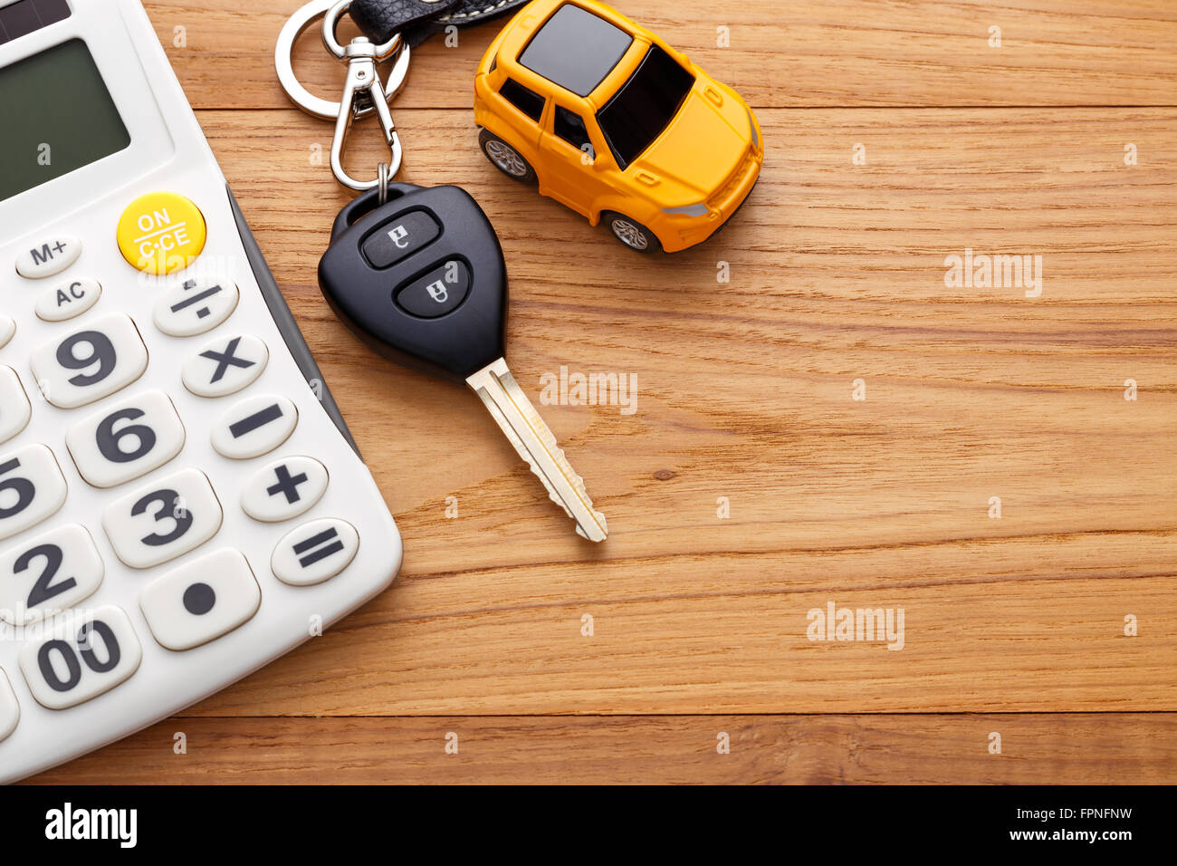 Car key with calculator on wood table background Stock Photo - Alamy