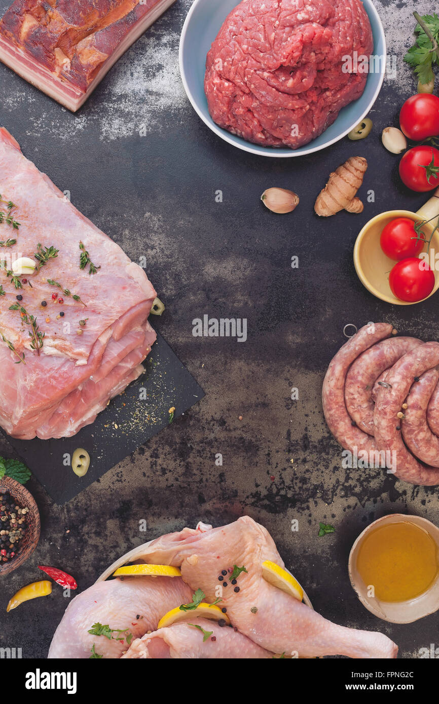 Raw meat assortment. Different types of meat with vegetables and spice ...