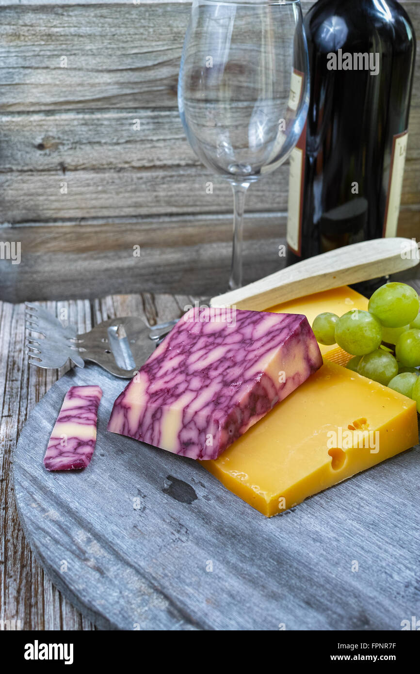 Dessert plate - mixed cheese, marble cheddar, grape and wine on wooden ...