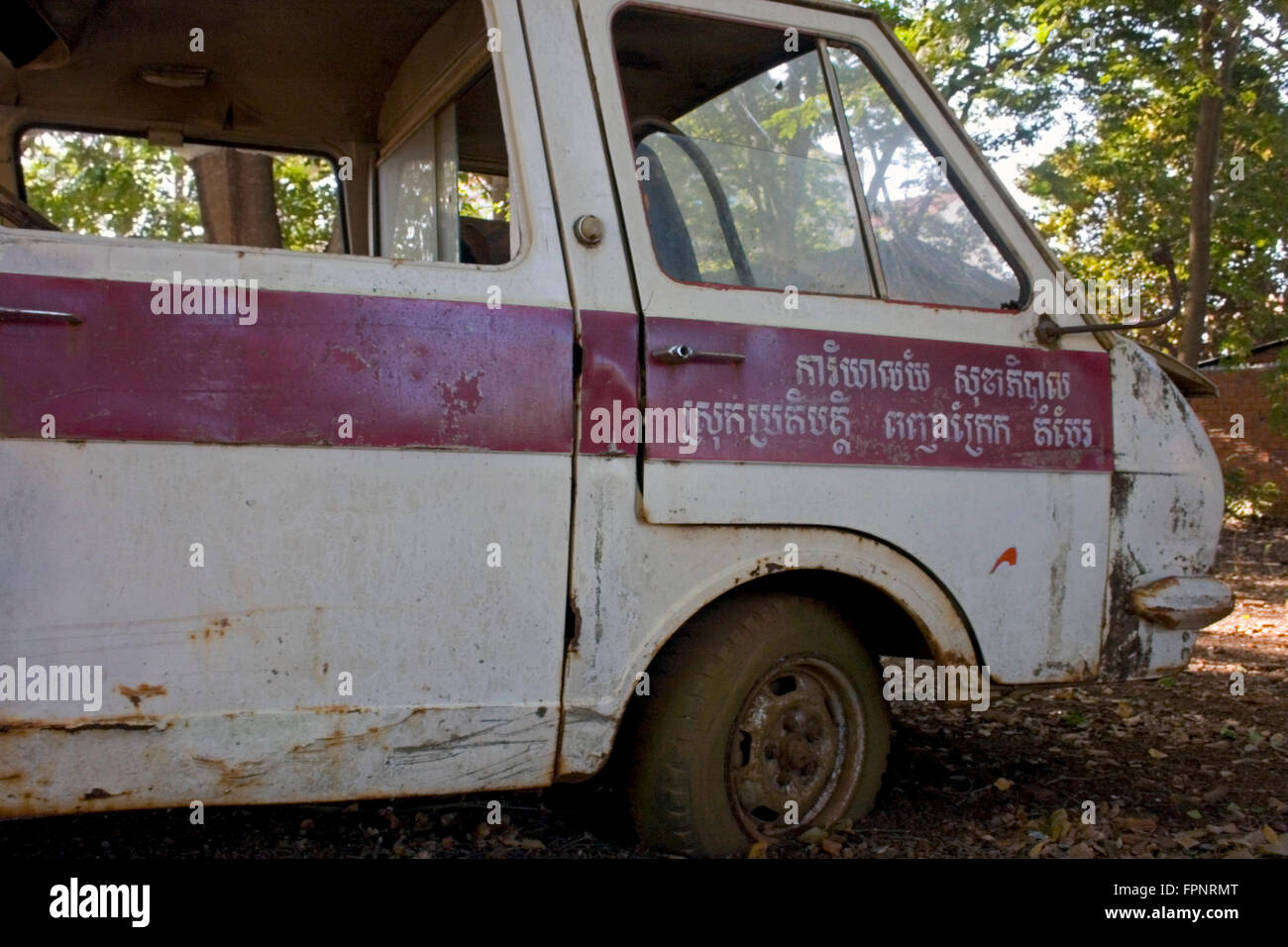 A dilapidated mini van loaded with fire wood sits outside Ou Reang Ov ...