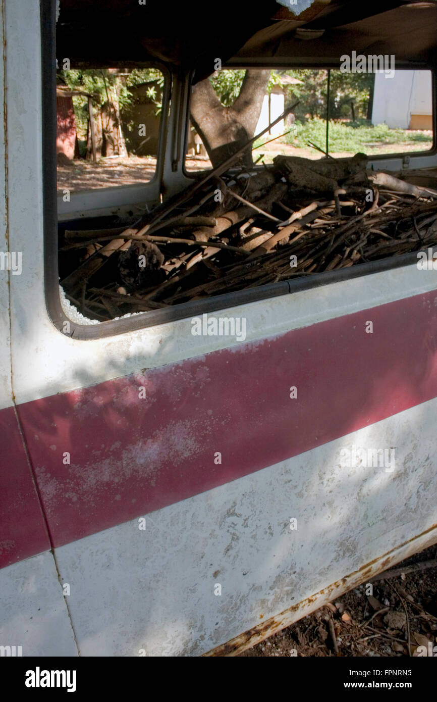 A dilapidated mini van loaded with fire wood sits outside Ou Reang Ov ...