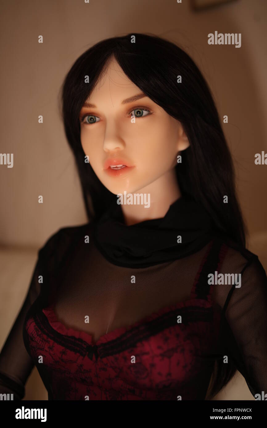 Life-Size silicone doll in in see through top and reddish torselett ...