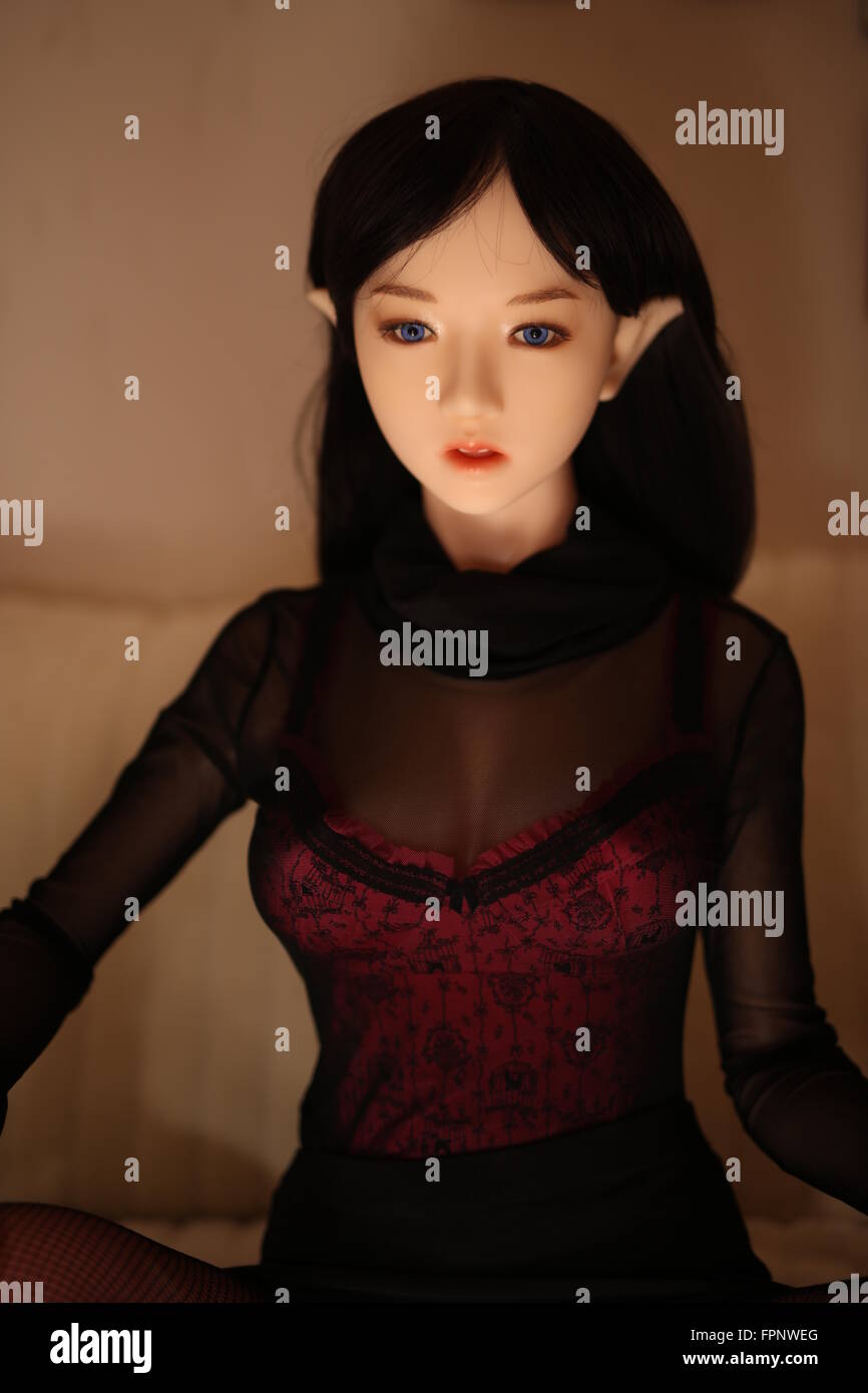 Life-Size silicone doll in in see through top and reddish torselett ...