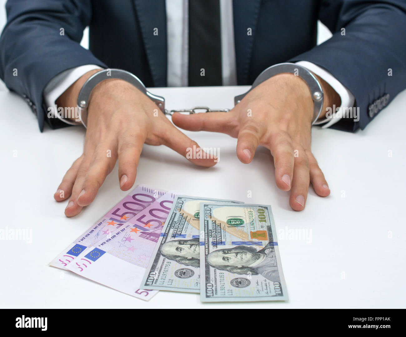 Greedy businessman handcuffed Stock Photo - Alamy