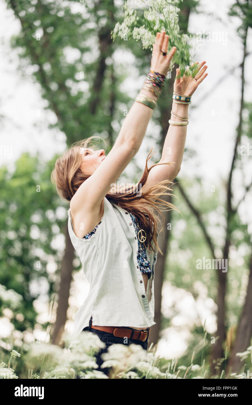 Young woman throwing flower bouquet in the air Stock Photo - Alamy
