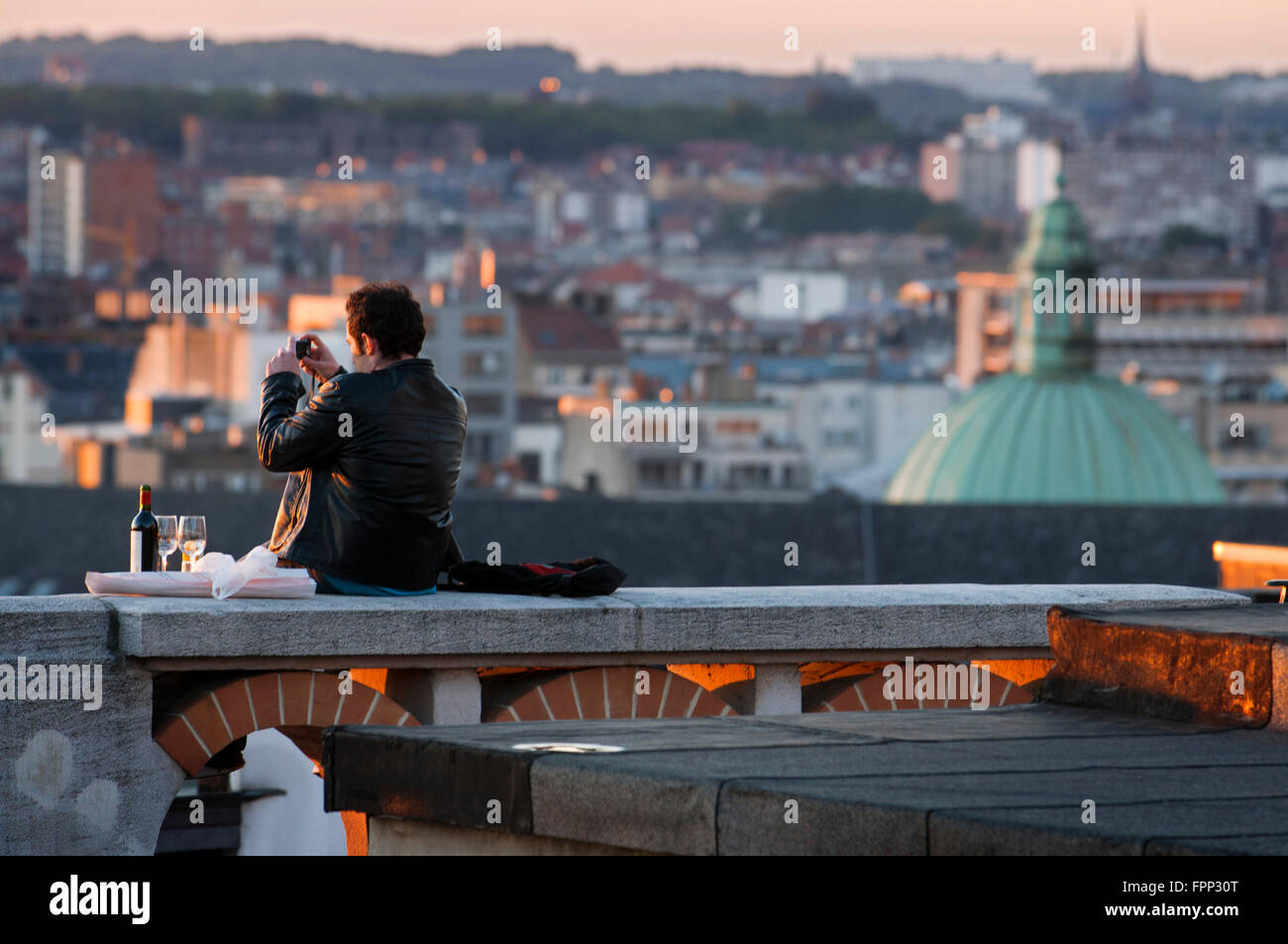 Marolles neighborhood, Brussels, Belgium. A man photographs the roofs ...