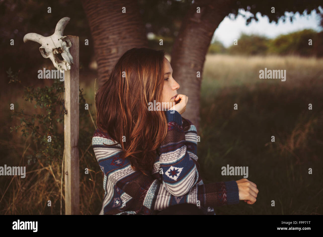 Woman sitting beside skull Stock Photo - Alamy