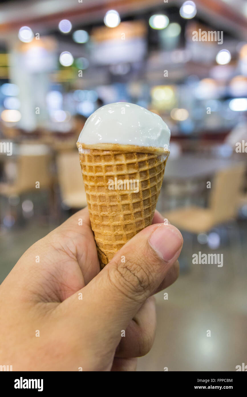 female hand holding vanilla ice cream Stock Photo - Alamy