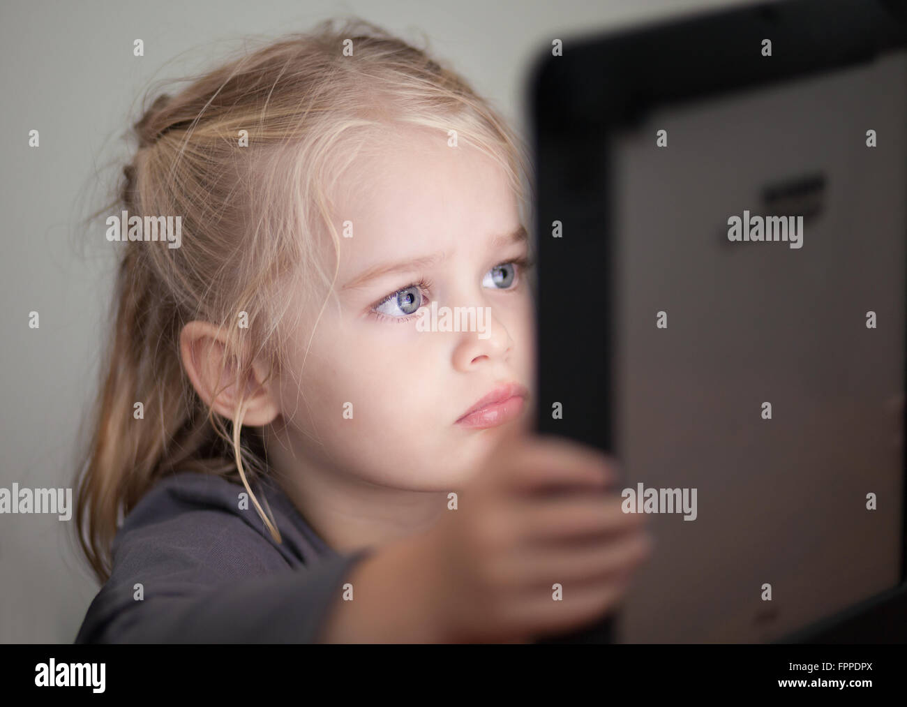 little girl playing on her IPAD Stock Photo - Alamy