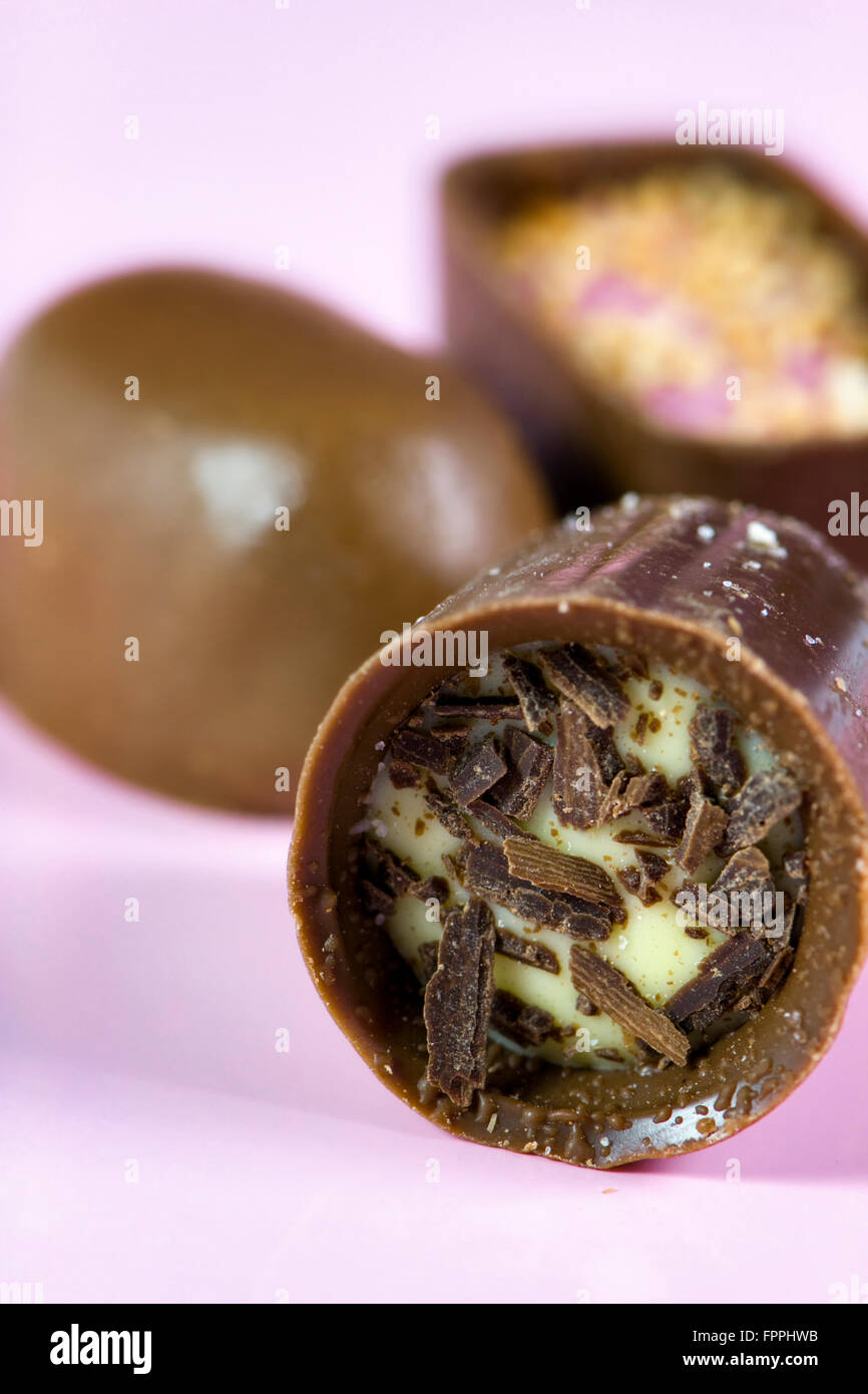 Close up of luxury continental or Belgian assorted chocolates on pink ...