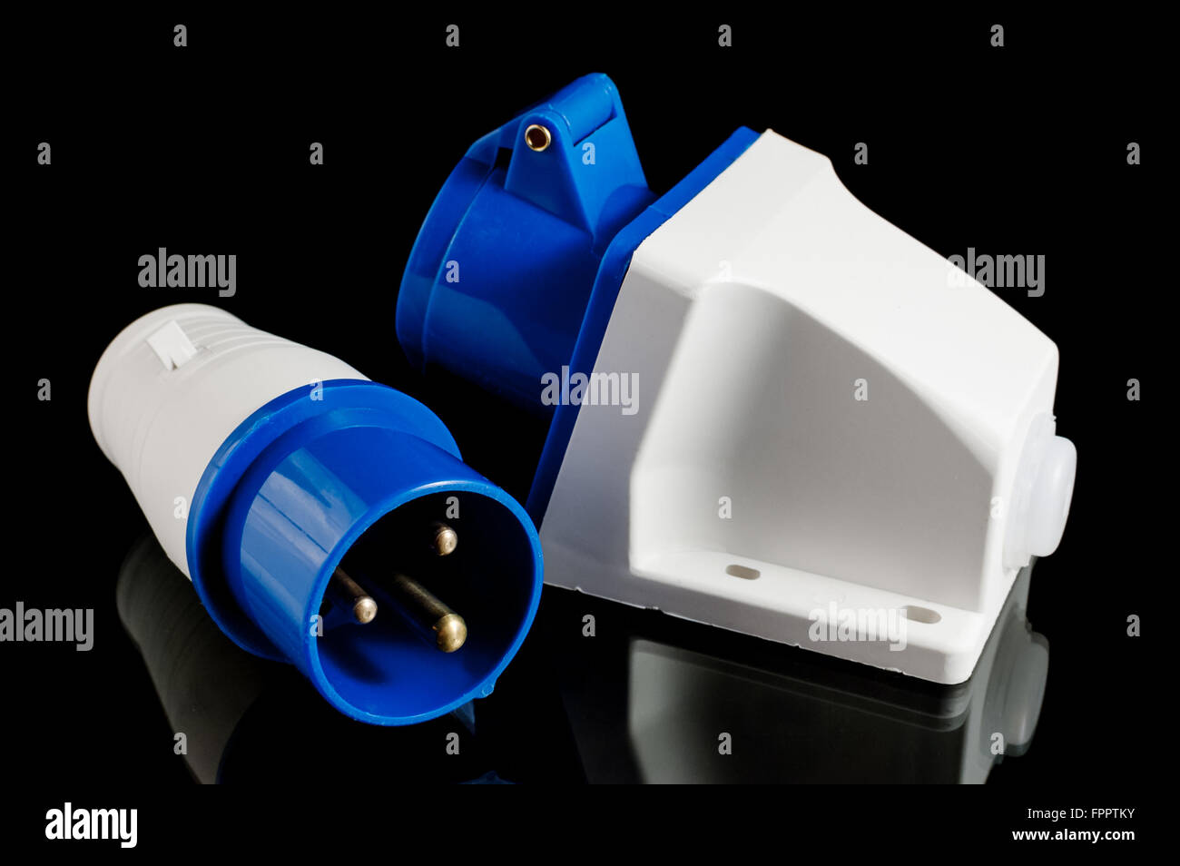 Electric plastic power plug and wall socket with cap isolated on black ...