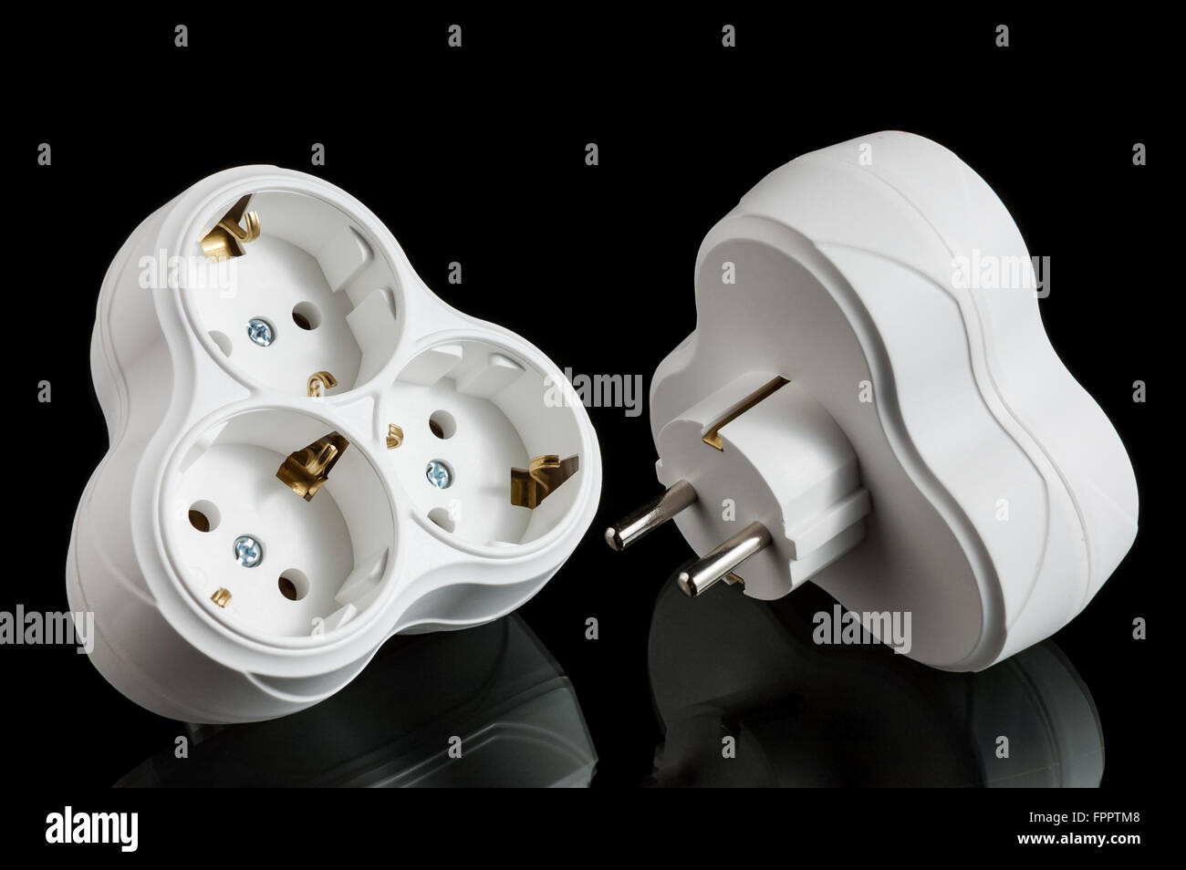 Triple electrical plug outlet on black background Stock Photo - Alamy