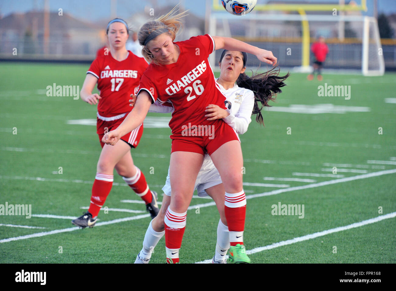 Players battle along the sideline in competition for a header during a ...