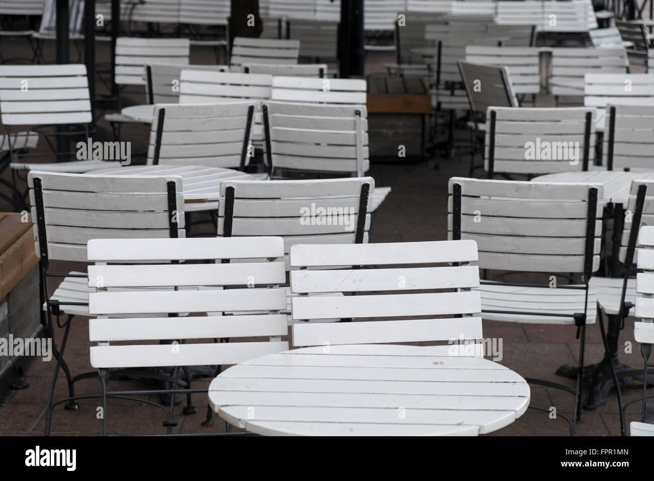 Bunch of white chairs and tables on an outside terrace of a bar Stock ...